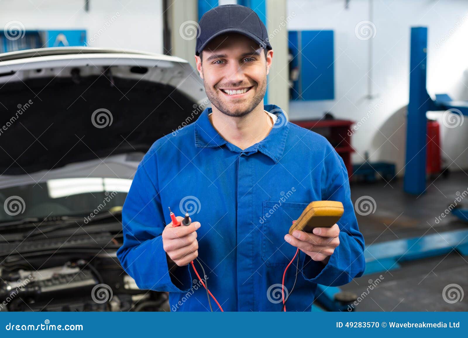 Mechanic Smiling at the Camera Holding Tool Stock Photo - Image of ...
