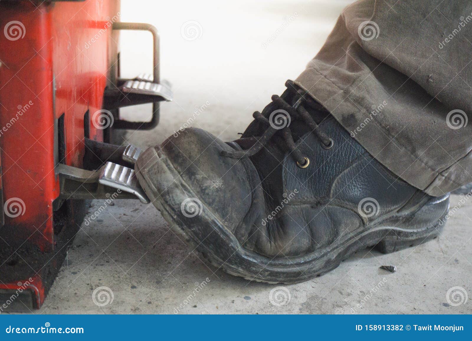 Mechanic Stepping on Tire Machine for Remove Tire from Wheel Stock ...