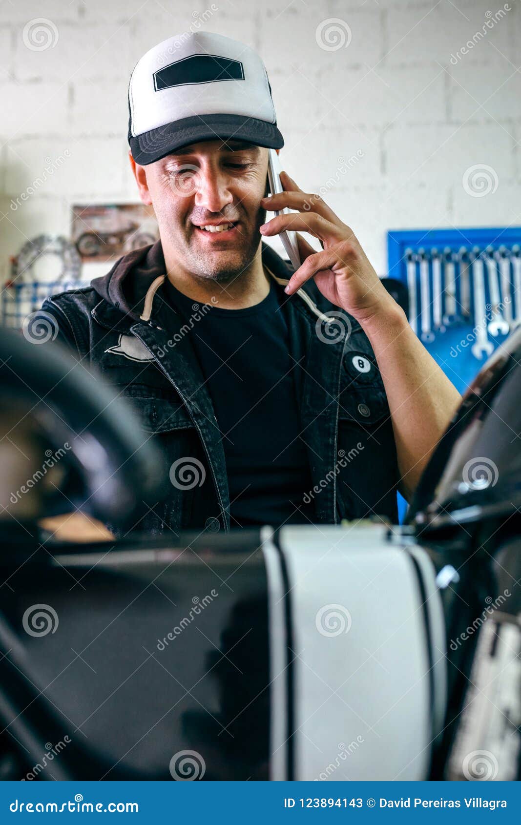 Mechanic Talking Phone while Fixing Motorbike Stock Image - Image of ...