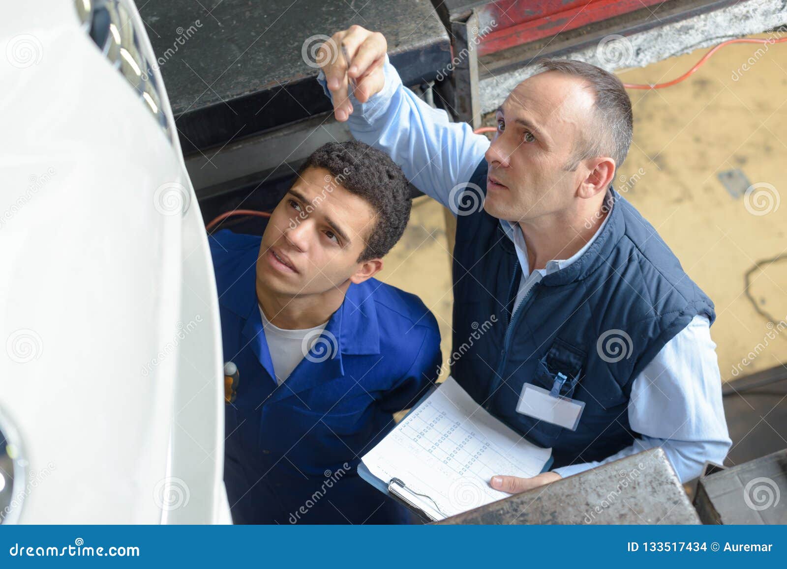 Mechanic Teaching Trainee in Garage Workshop Stock Photo - Image of ...