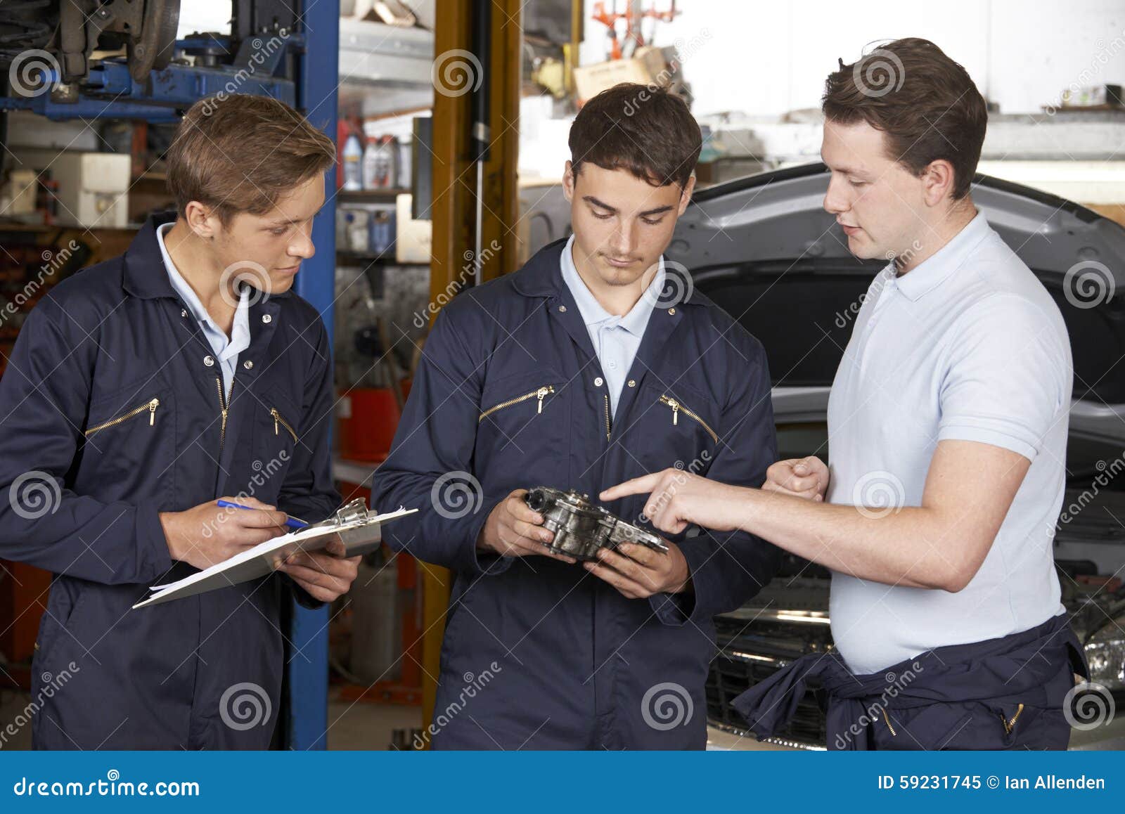 Mechanic Teaching Trainees in Garage Workshop Stock Image - Image of ...