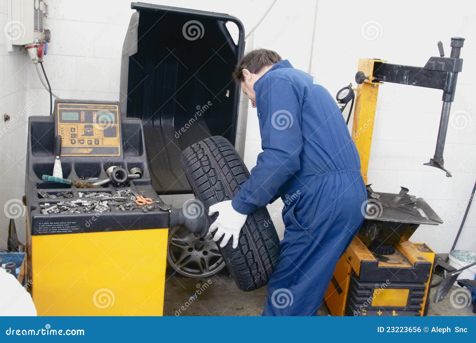 Mechanic and tire stock photo. Image of tool, garage - 23223656