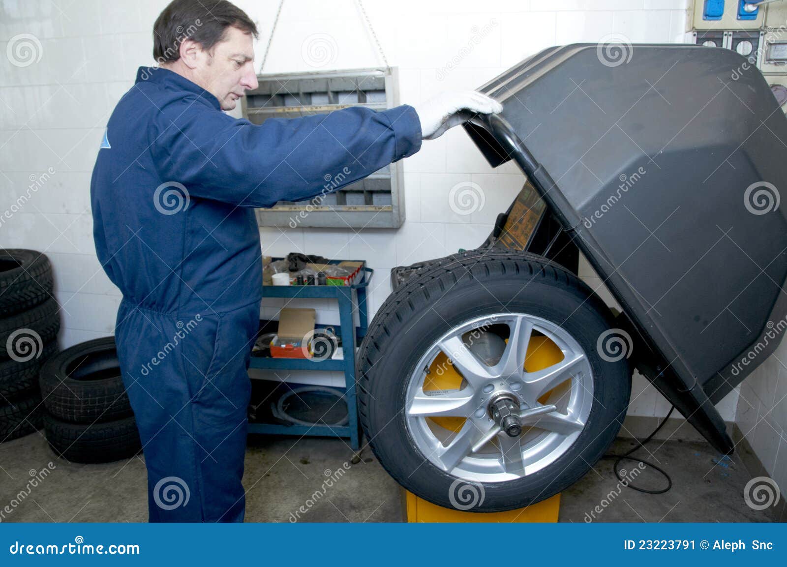 Mechanic and tire stock image. Image of work, tool, repair - 23223791