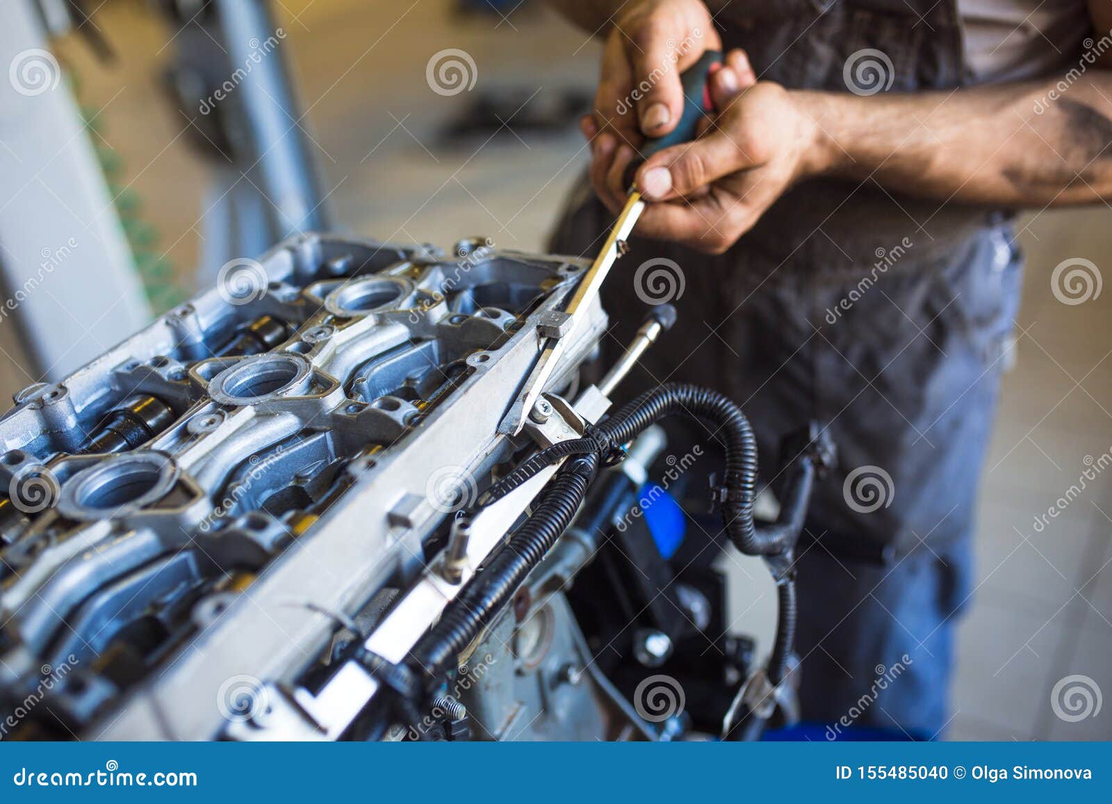Mechanic with a Tool in His Hands Repairing the Motor of the Machine ...