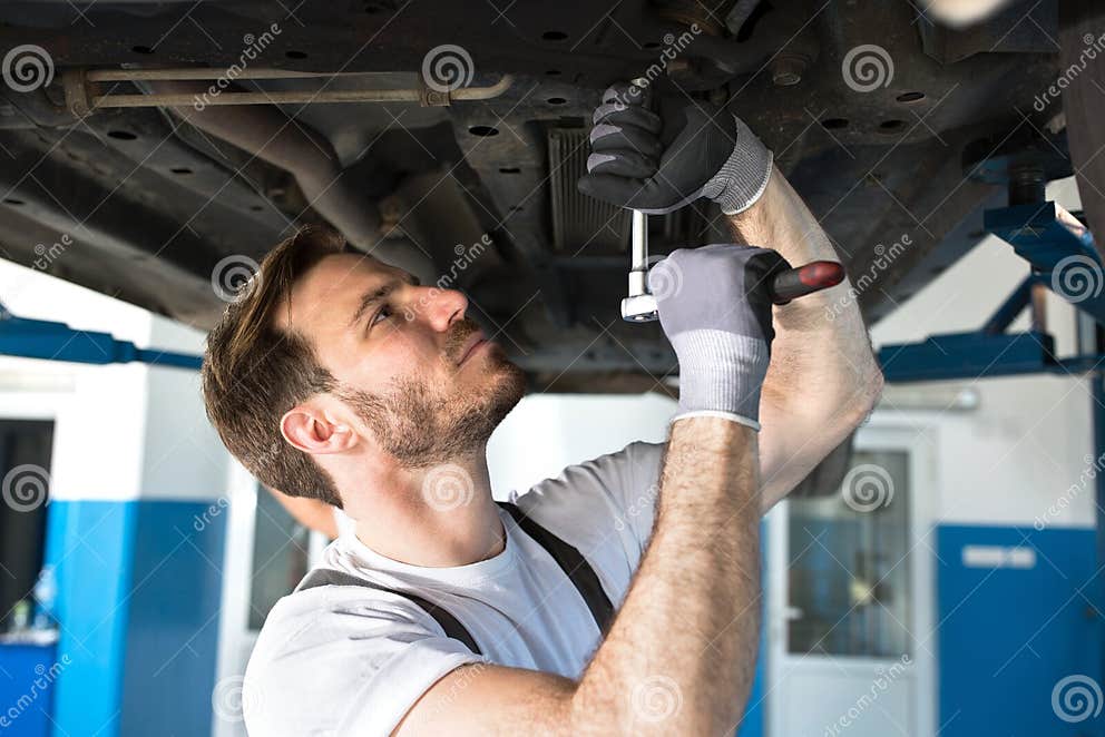 Mechanic with a Tool Under the Car Stock Image - Image of service ...