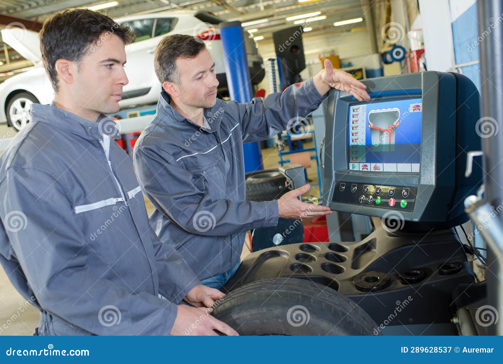 Mechanic Training Colleague To Use Computerised Equipment Stock Image ...