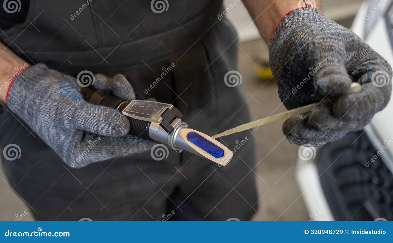 A Mechanic Uses a Refractometer in a Car Service. Portable Optical ...