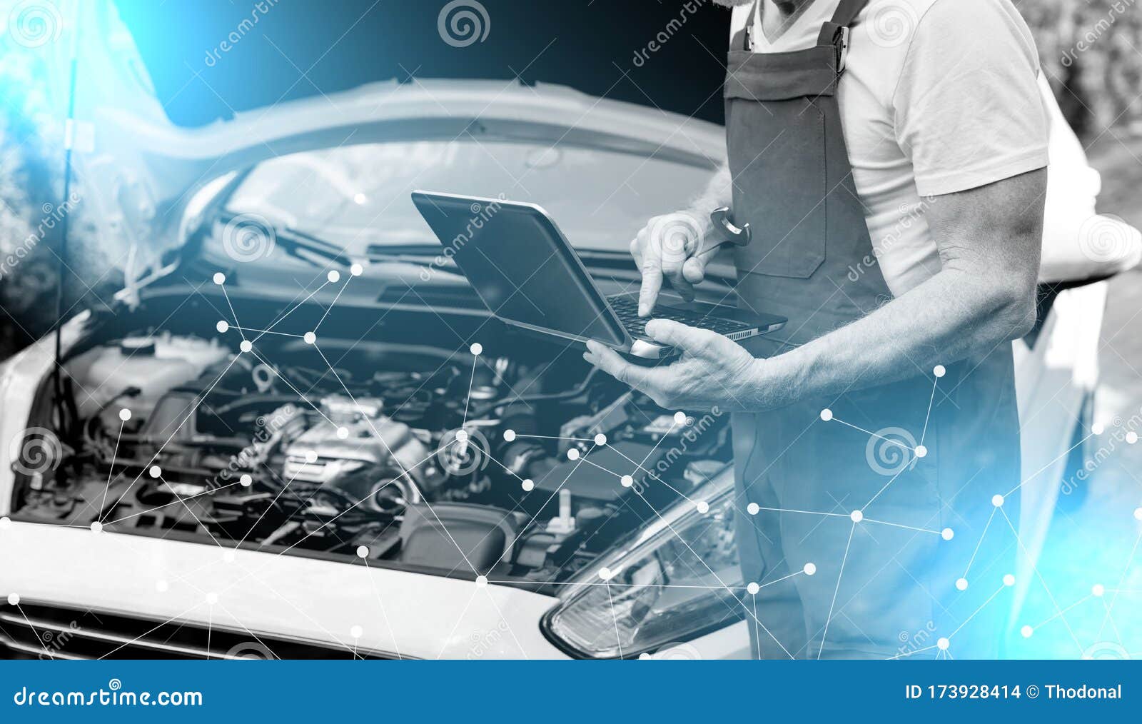 Mechanic Using Laptop for Checking Car Engine; Light Effect Stock Photo ...