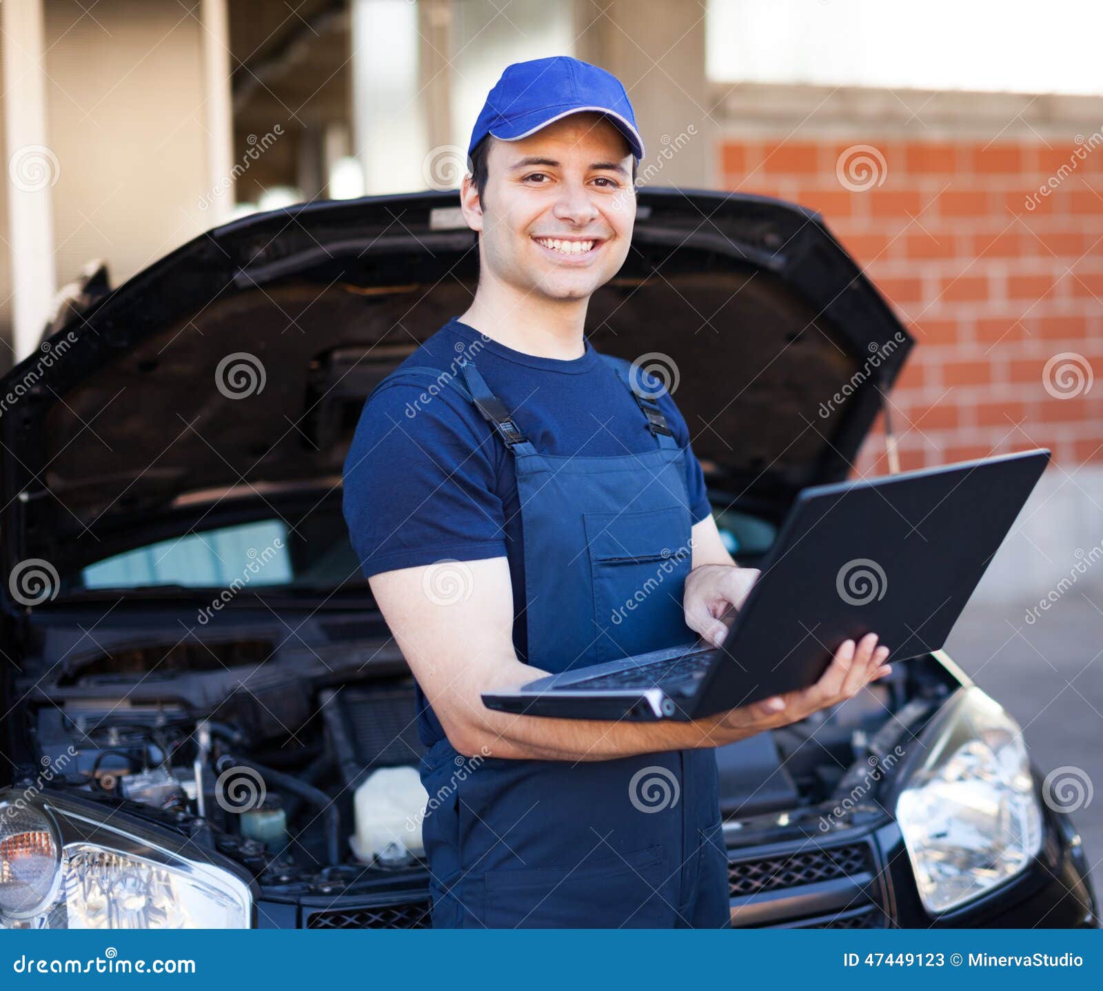 Mechanic Using a Laptop Computer To Check a Car Engine Stock Image ...