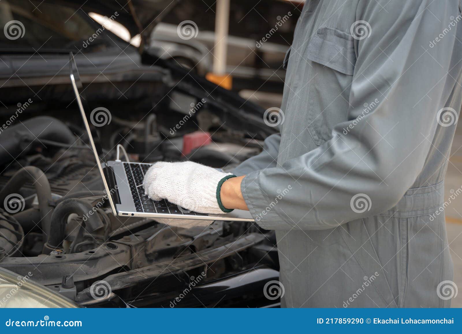 Mechanic Using a Laptop Computer To Check Collect Information during ...