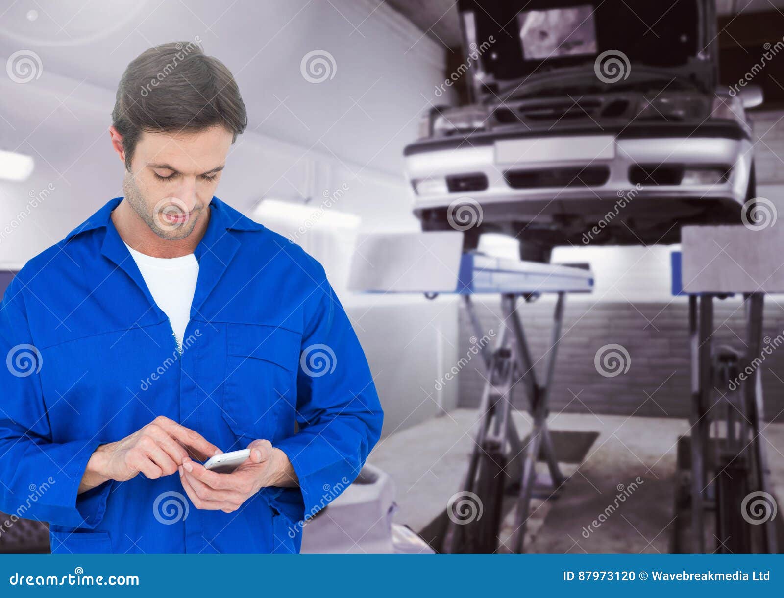 Mechanic Using Mobile Phone at Garage Stock Photo - Image of caucasian ...