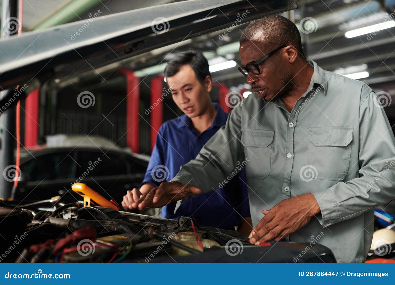 Mechanic Using Multimeter stock image. Image of repair - 287884447