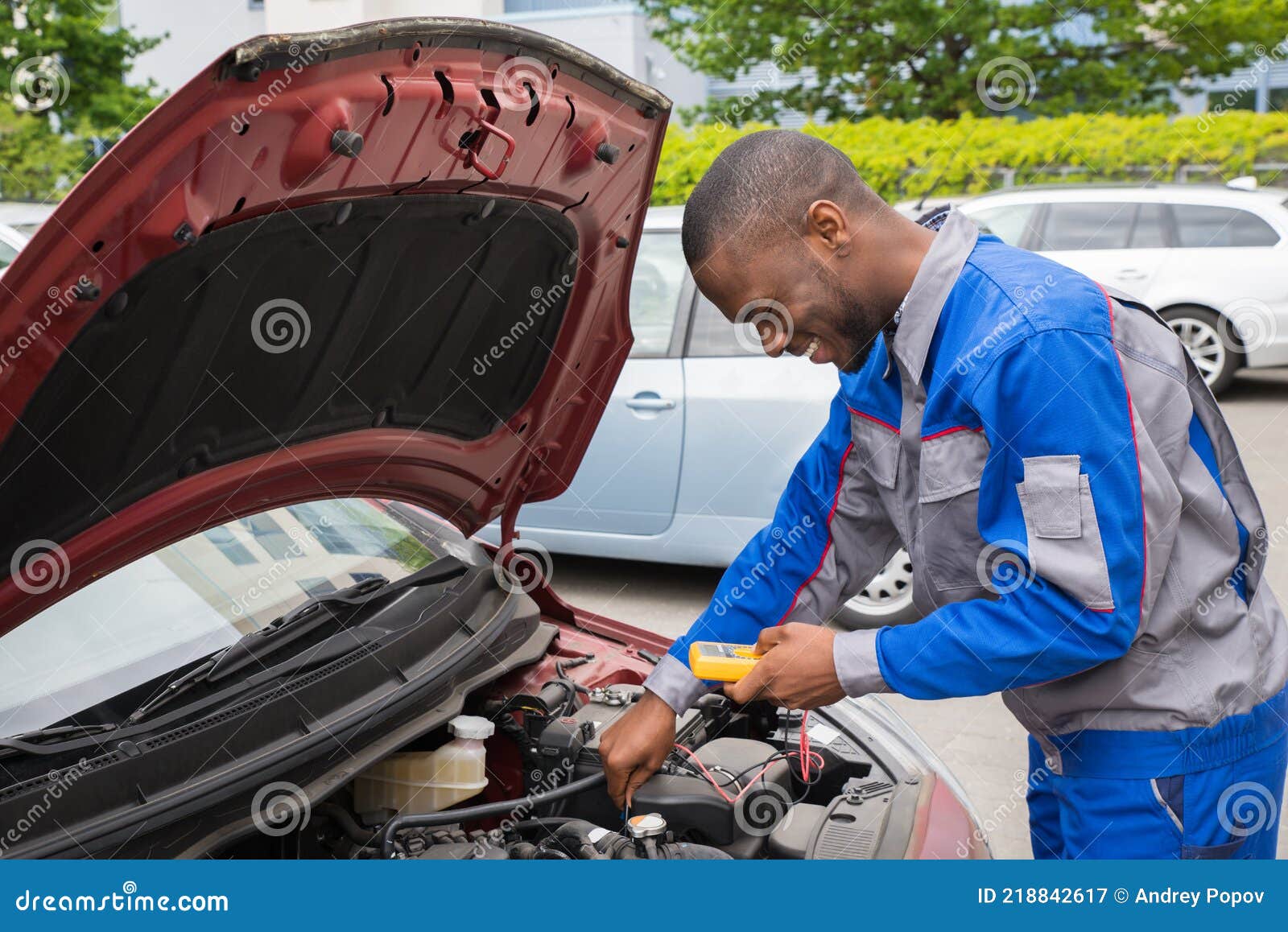 Mechanic Using Multimeter To Check Car Battery Stock Image - Image of ...