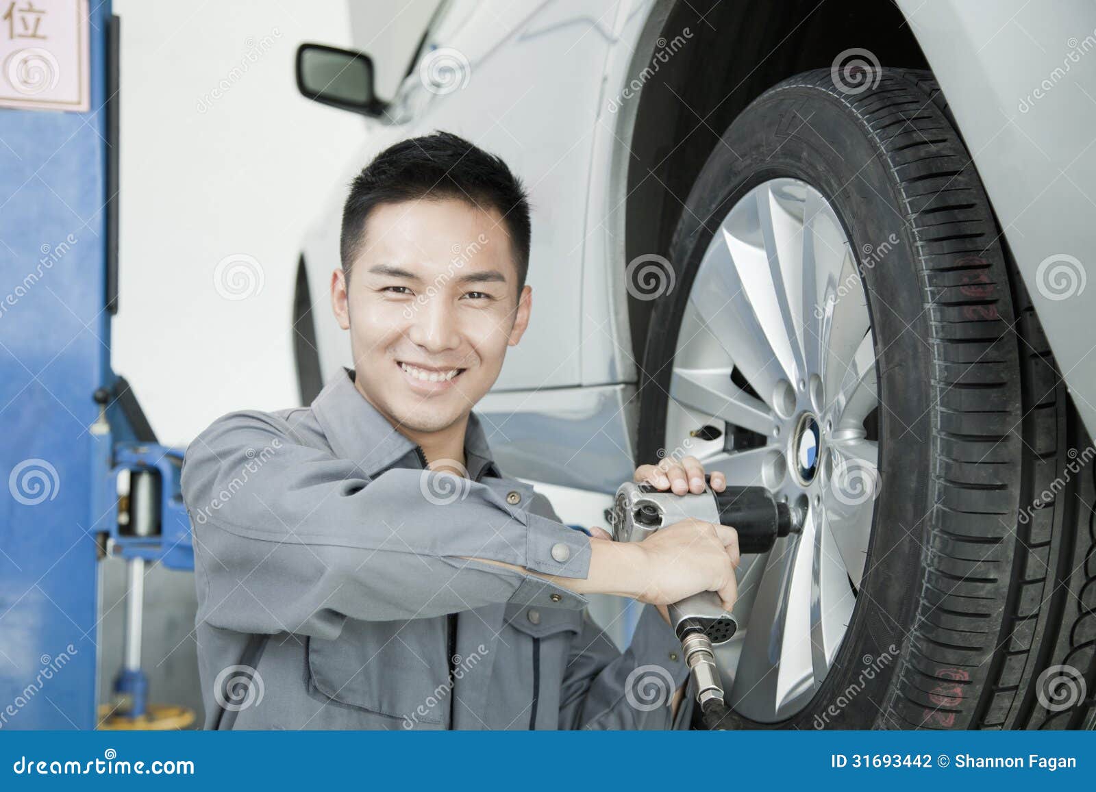 Mechanic Using Power Tool stock photo. Image of indoors - 31693442