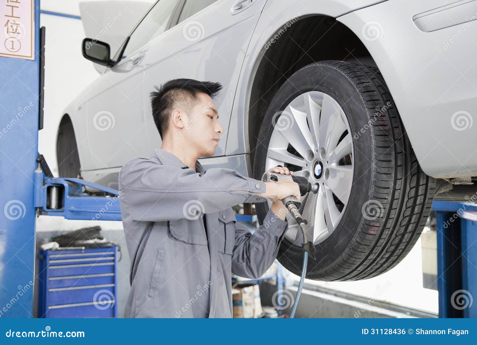 Mechanic Using Power Tool on Car Wheel Stock Photo - Image of real ...