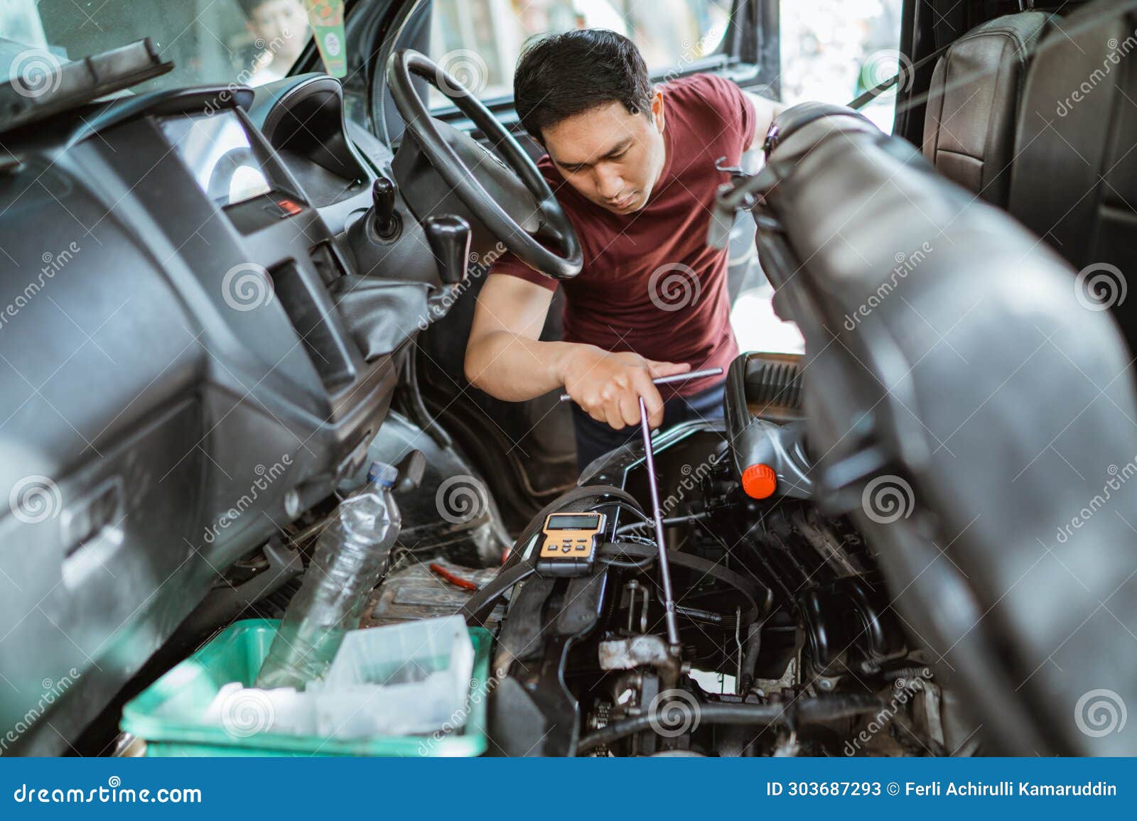 Mechanic Using T Socket To Repair the Engine Under the Car Seat Stock ...
