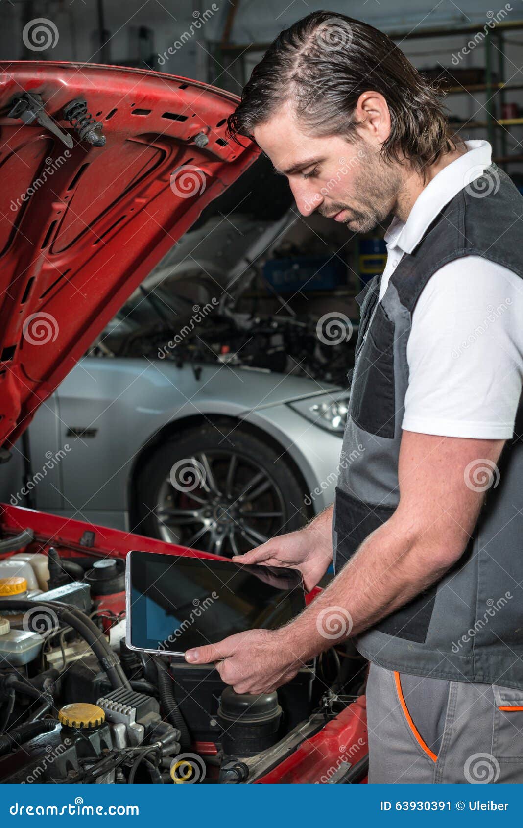 Mechanic Using a Tablet Pc at the Repair Garage Stock Image - Image of ...