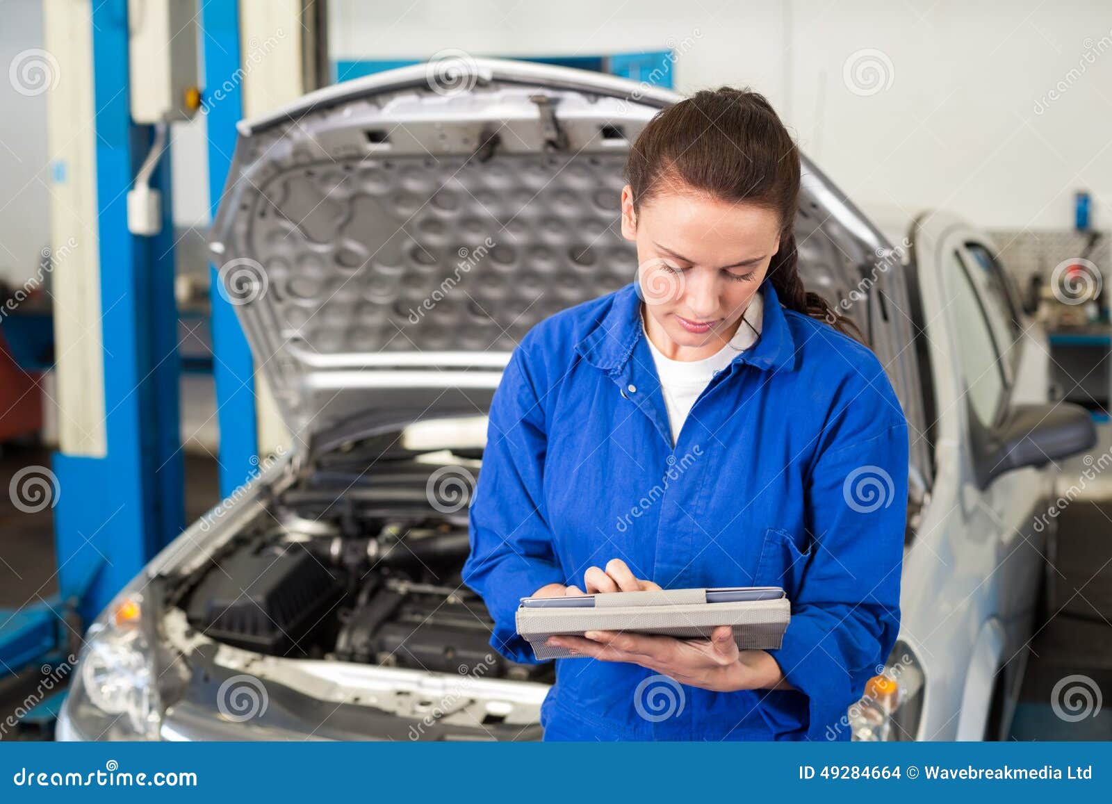 Mechanic Using Tablet To Fix Car Stock Photo - Image of attentively ...