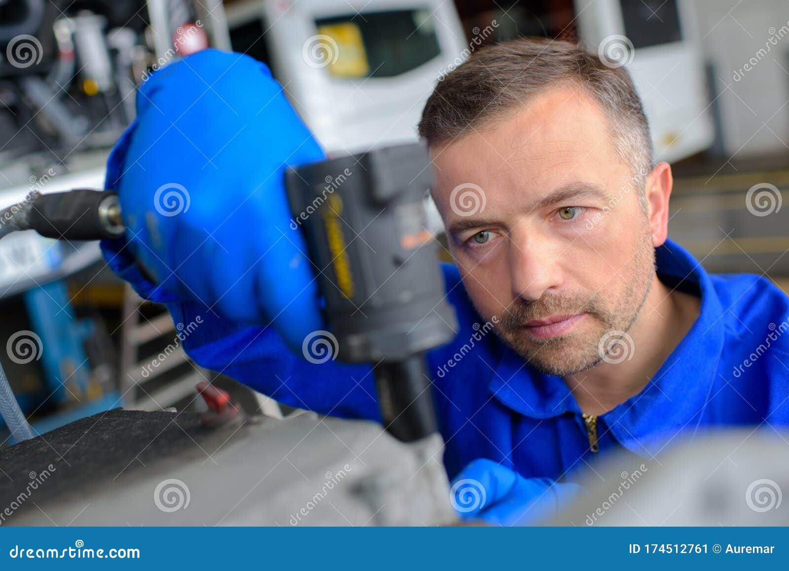 Mechanic using tool stock image. Image of project, workwear - 174512761