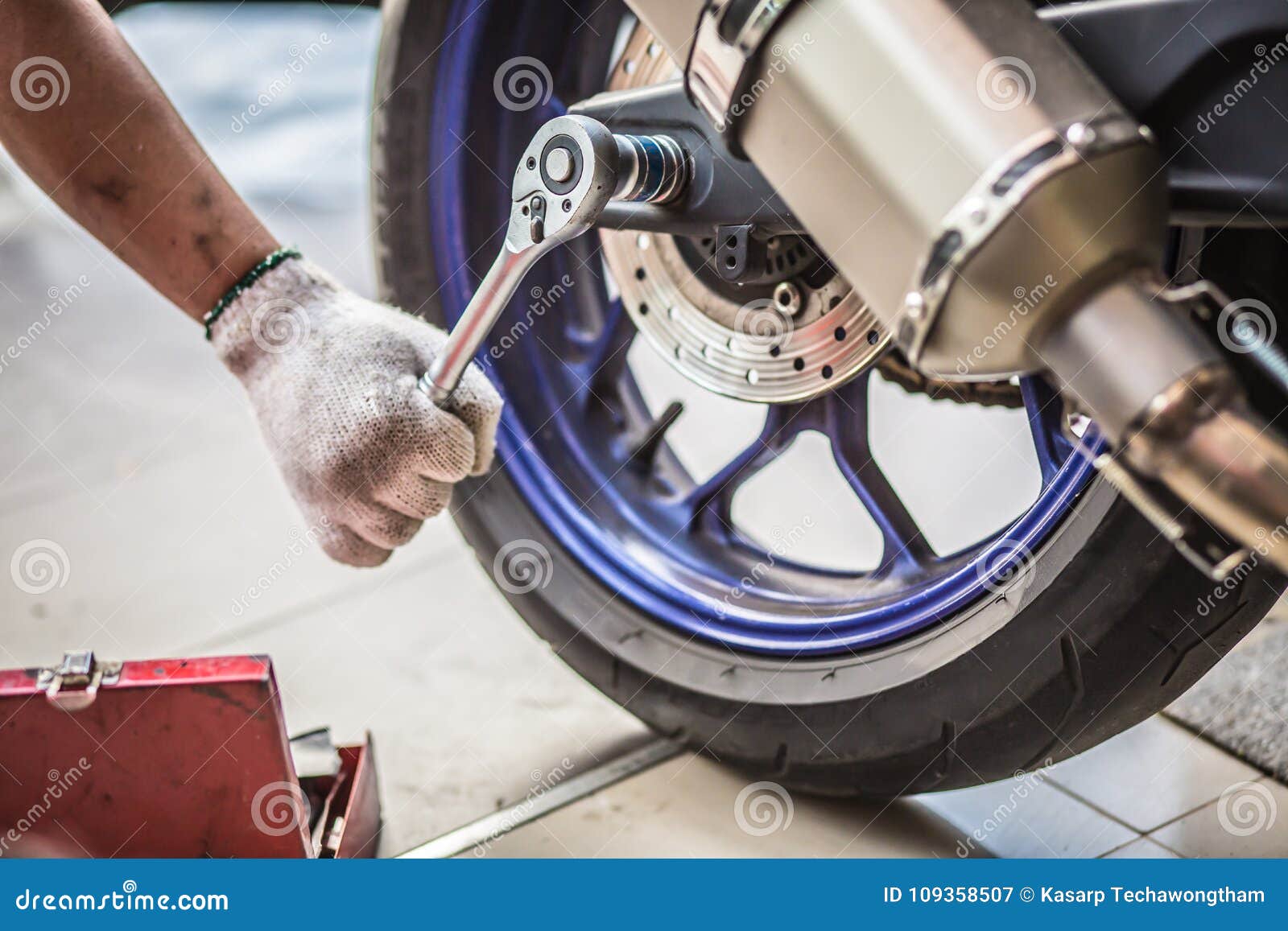 Mechanic Using a Wrench and Socket on the Engine of a Motorcycle Stock ...