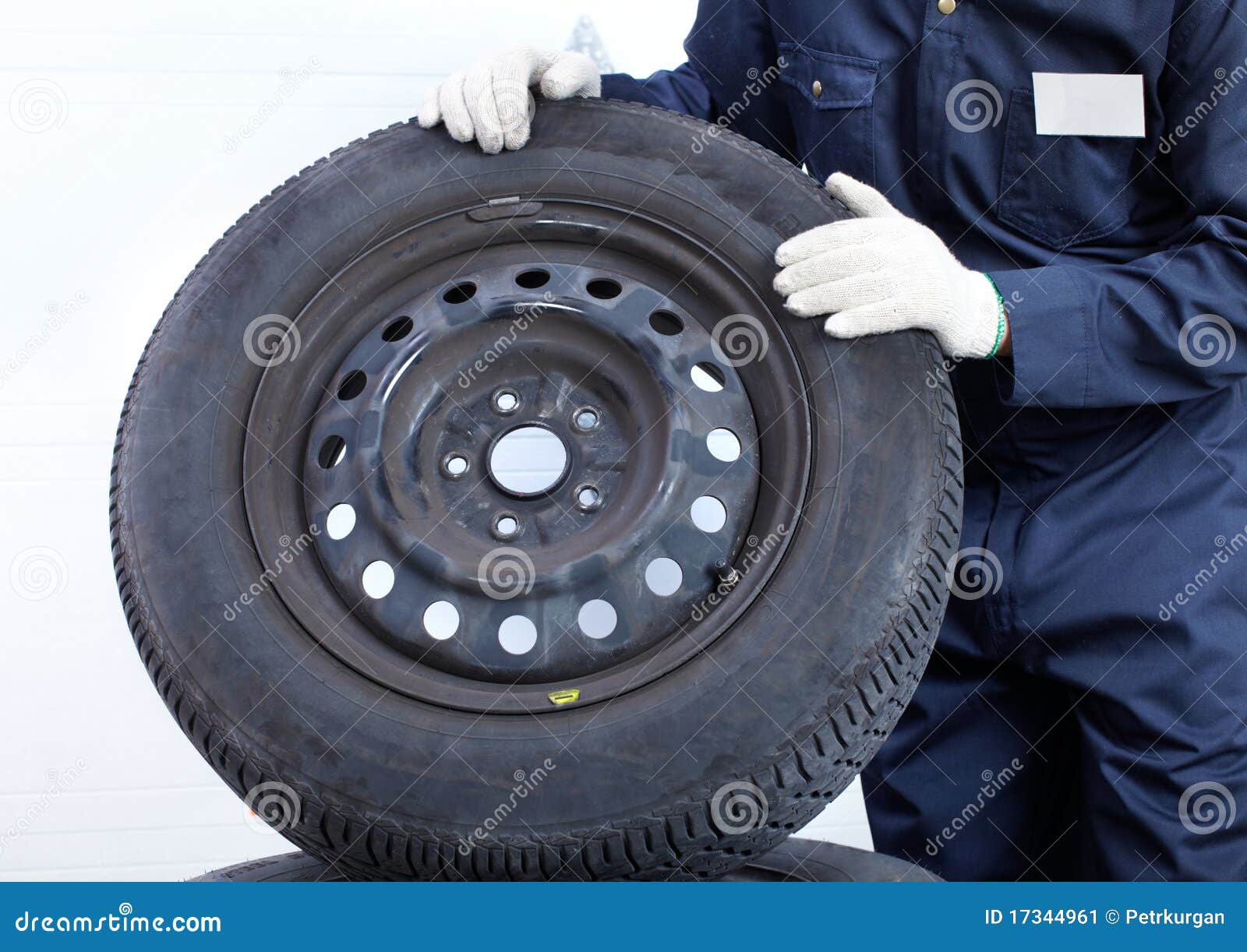 Mechanic with a wheel stock image. Image of engineering - 17344961