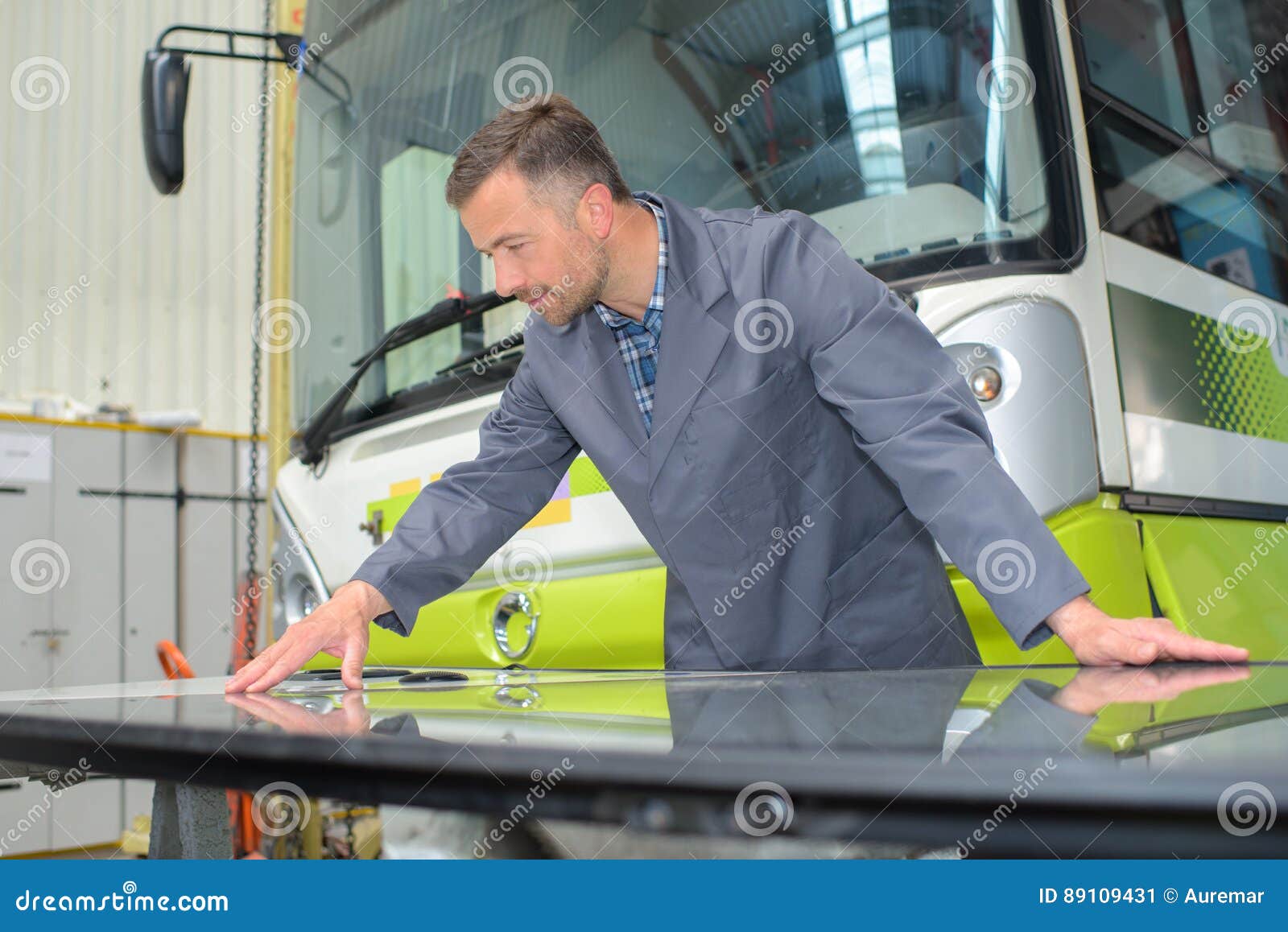 Mechanic working on bus stock image. Image of industry - 89109431
