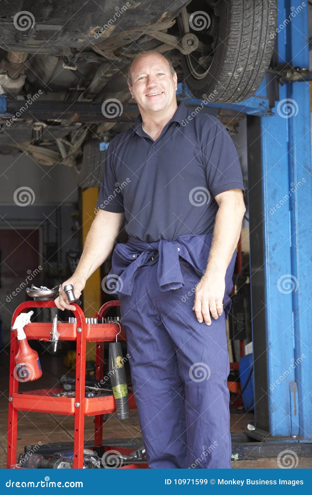 Mechanic working on car stock image. Image of person - 10971599