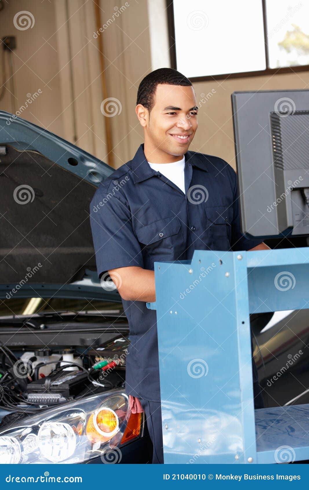 Mechanic working on car stock photo. Image of person - 21040010