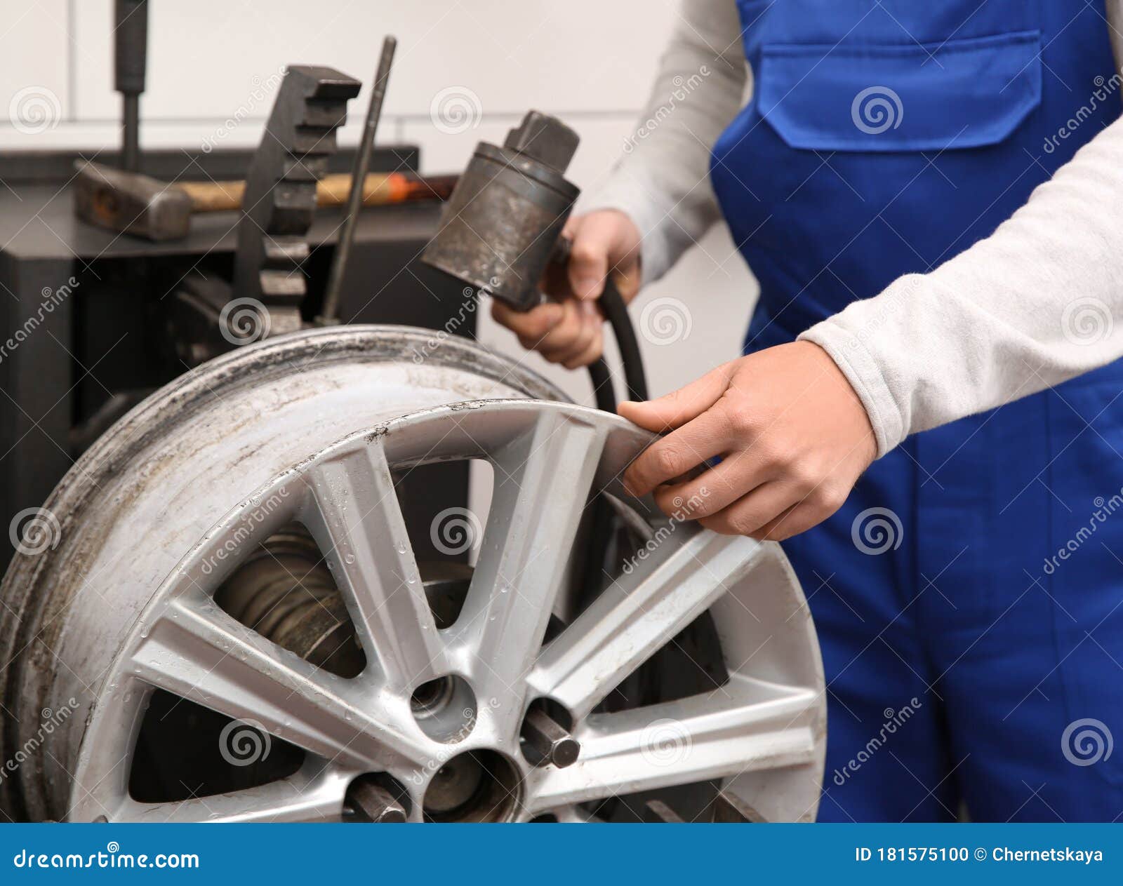 Mechanic Working with Car Disk Lathe Machine at Tire Service Stock ...