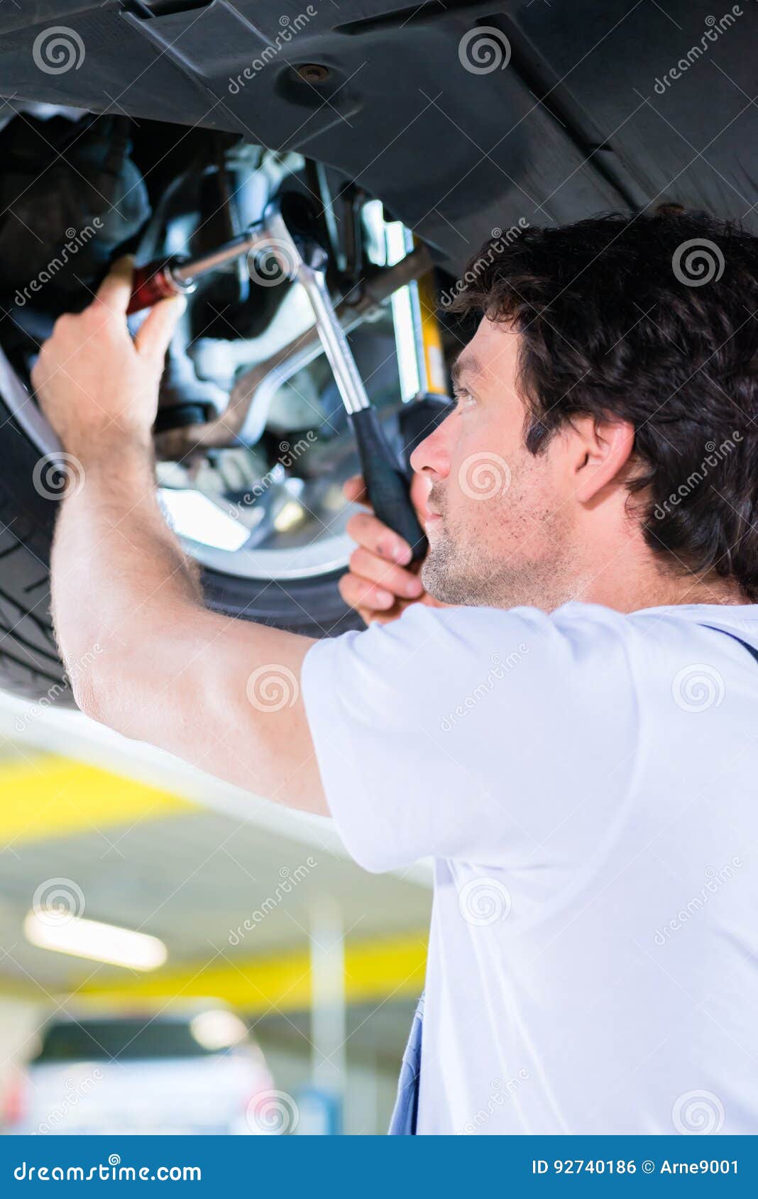 Mechanic Working in Car Workshop on Wheel Stock Photo - Image of wheel ...