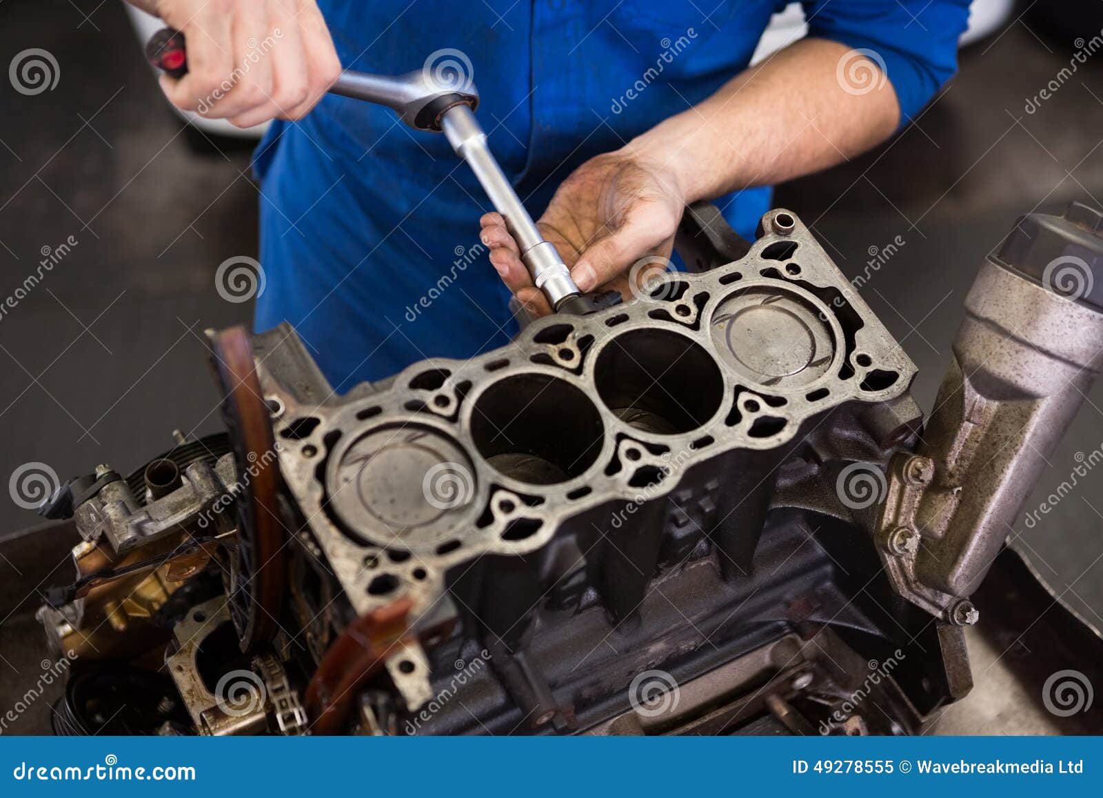 Mechanic Working on an Engine Stock Image - Image of holding, caucasian ...