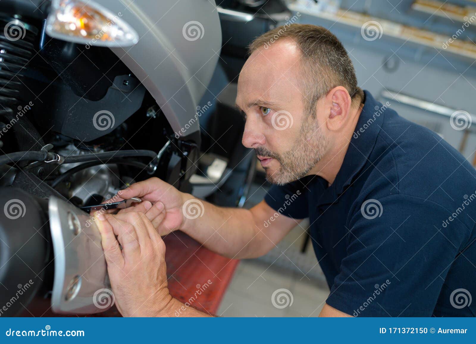 Mechanic Working on Modern Scooter Stock Photo - Image of beard ...