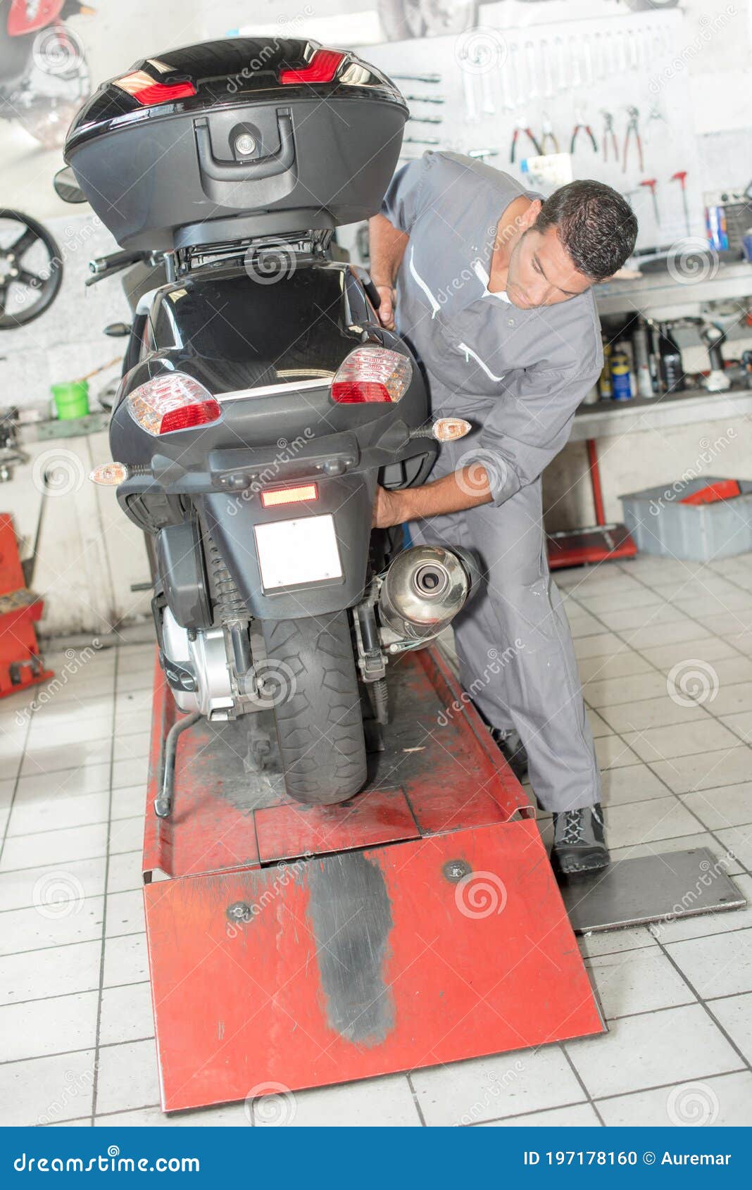 Mechanic Working on Modern Scooter Stock Photo - Image of clean, moped ...