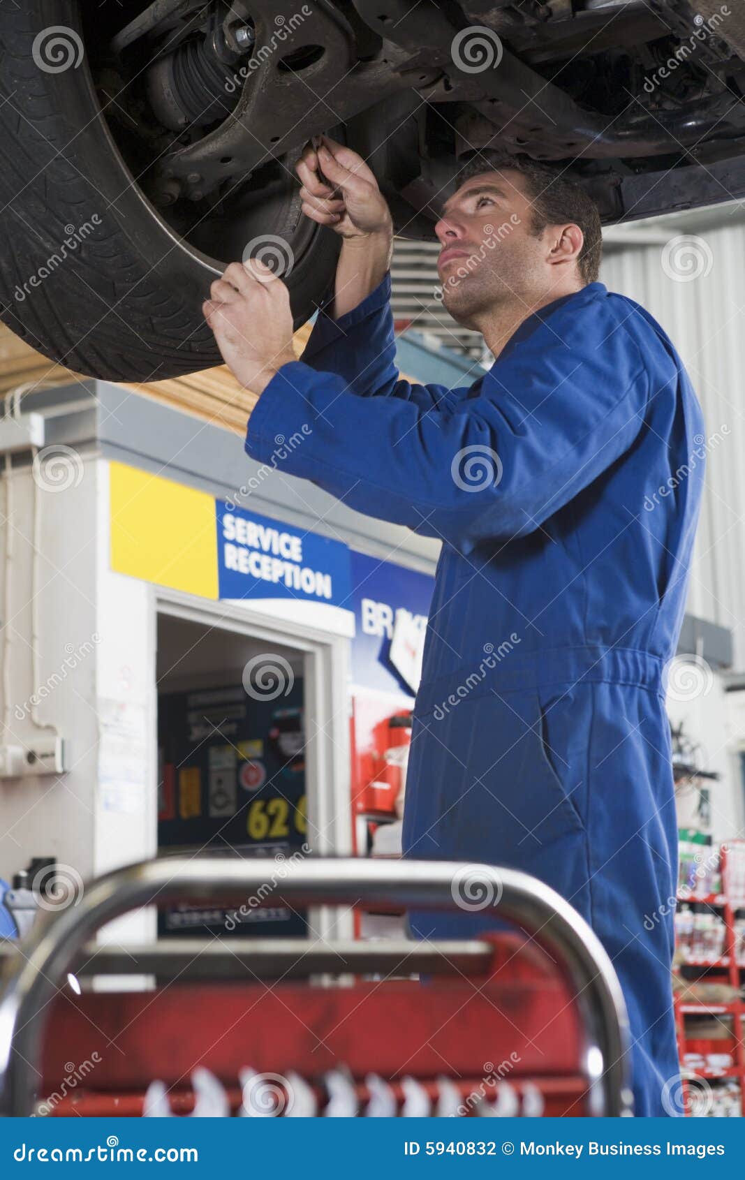 Mechanic working under car stock photo. Image of quarter - 5940832