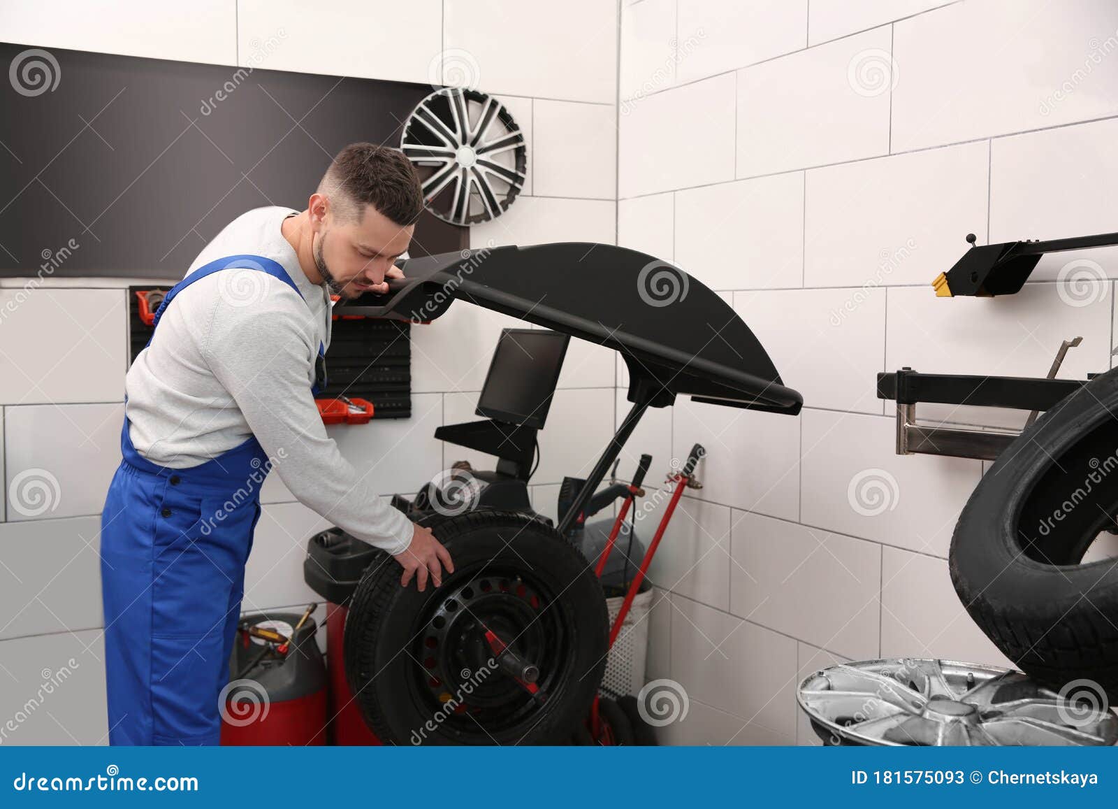 Mechanic Working with Wheel Balancing Machine at Service Stock Image ...