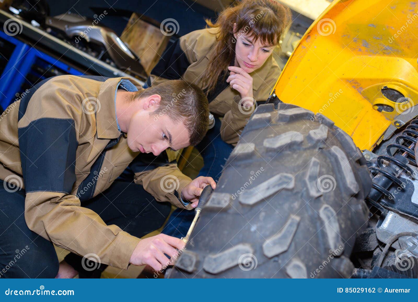 Mechanic Working on Wheel Buggy Stock Photo - Image of industry, women ...