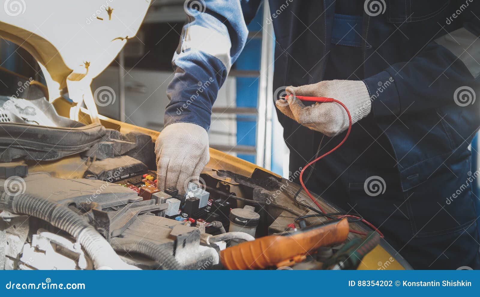 Mechanic Works Car Electrics with Voltmeter - Electrical Wiring Stock ...