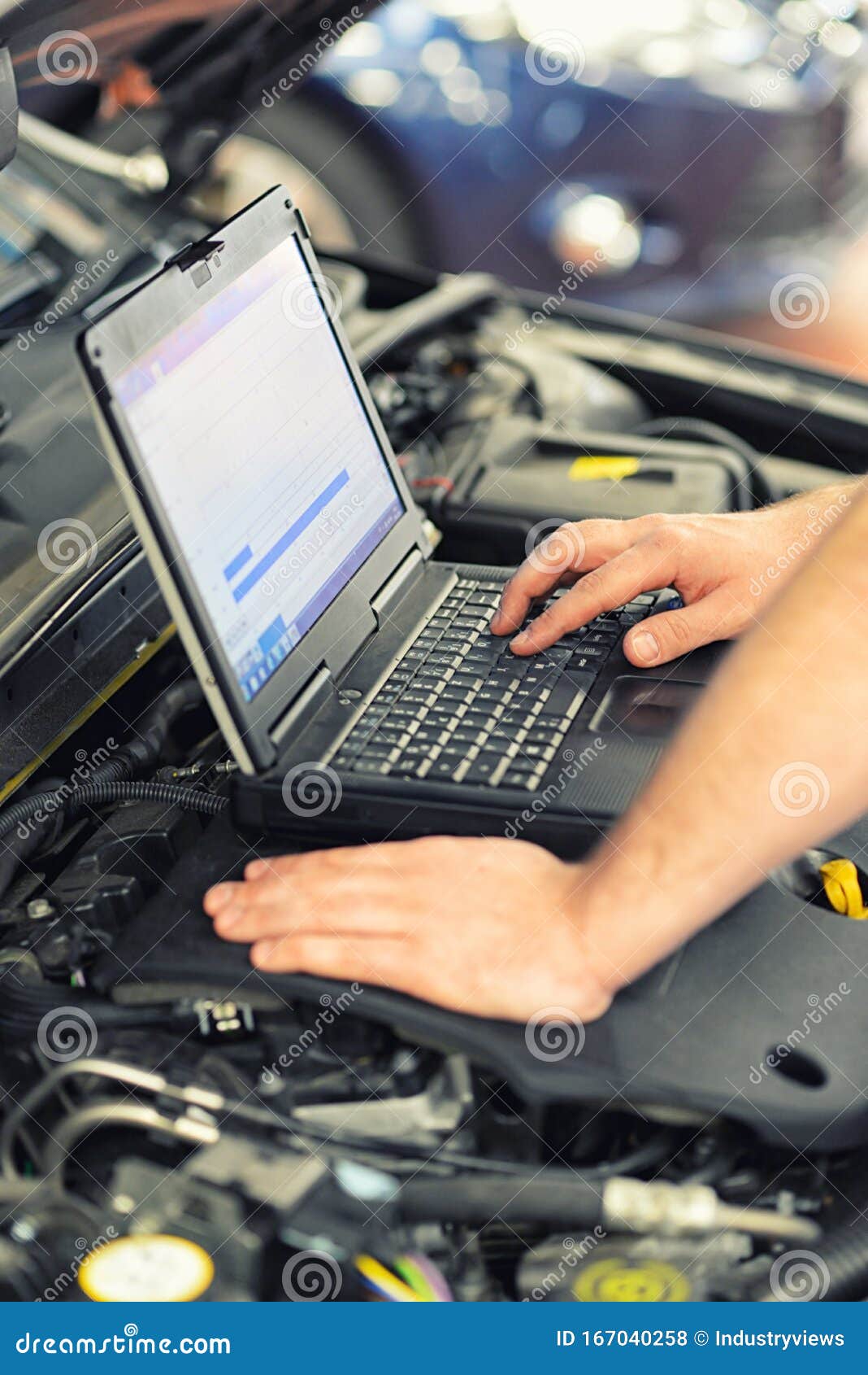 Mechanic in a Workshop Checks and Checks the Electronics of the Car ...