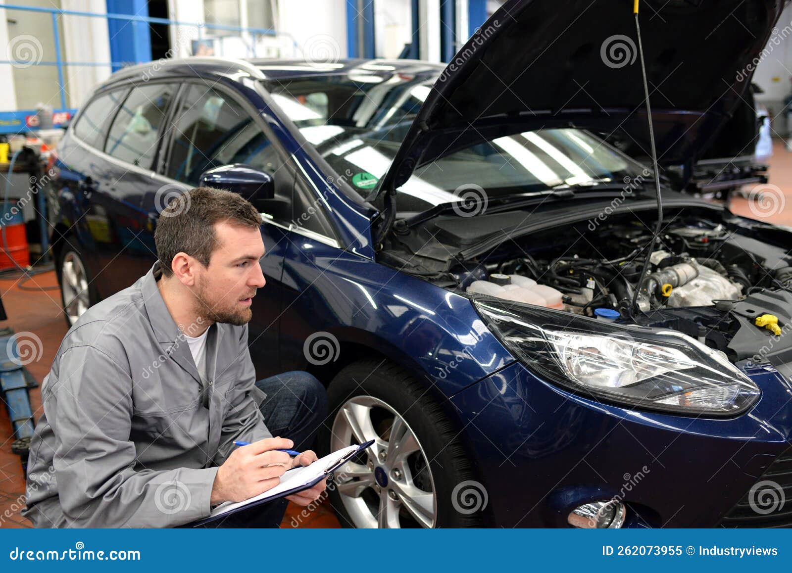 Mechanic In A Workshop Checks And Inspects A Vehicle For Defects ...