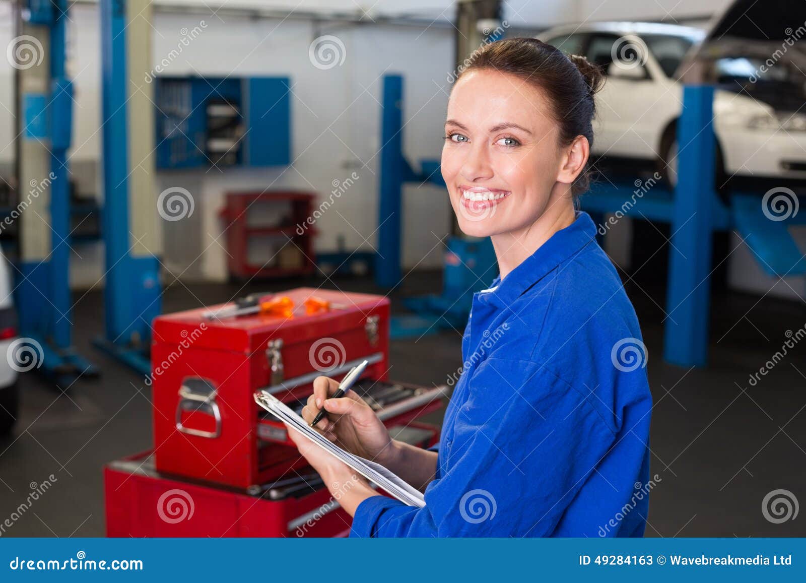 Mechanic Writing on a Clipboard Stock Image - Image of woman, machinist ...