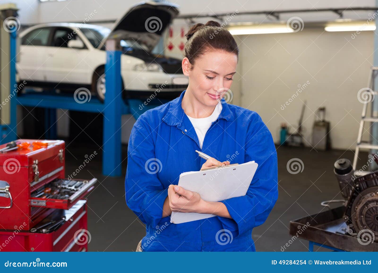 Mechanic Writing on a Clipboard Stock Photo - Image of working, garage ...