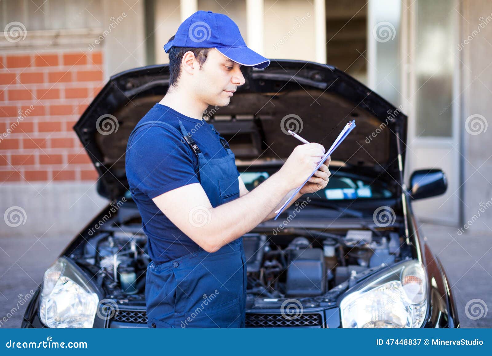 Mechanic Writing on a Clipboard Stock Image - Image of manual, garage ...