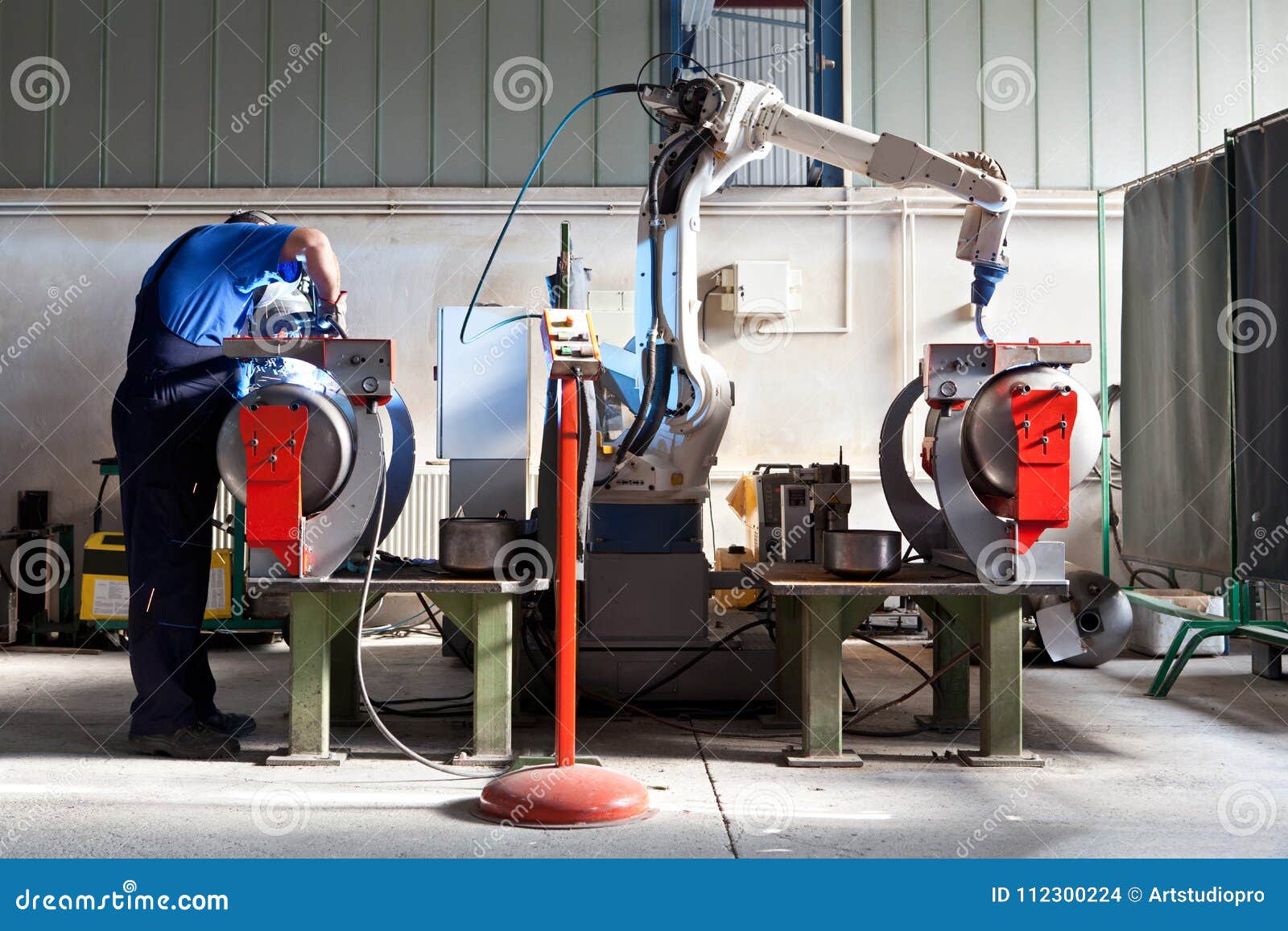Man and Robotic Machine Work Together Inside Industrial Building. Stock ...