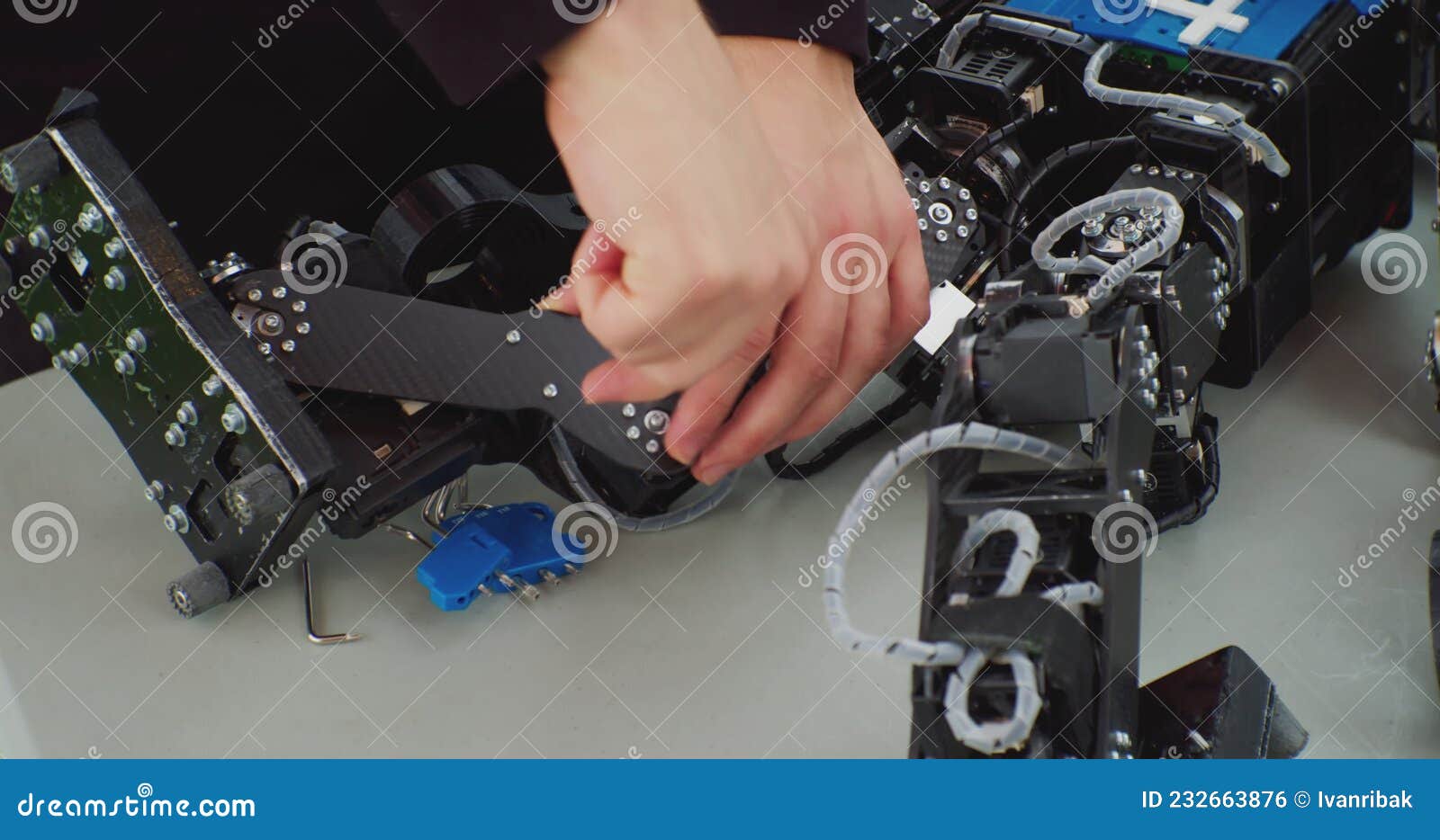 Mechanical Assembly of the Robot Using a Screwdriver. Hands of a ...