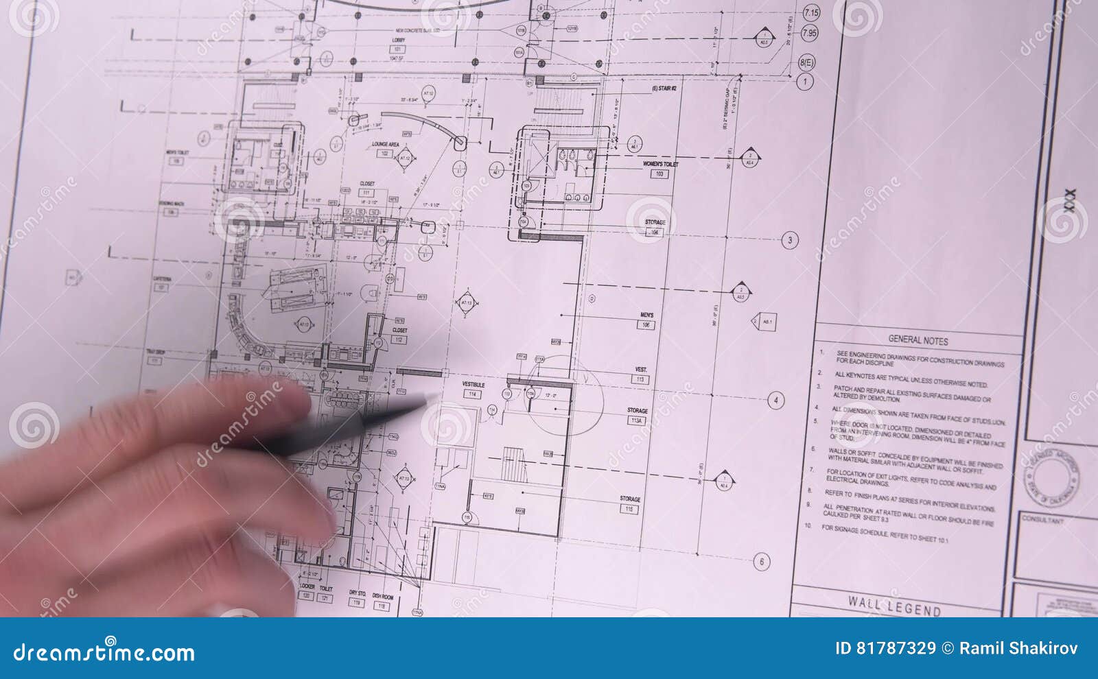 Mechanical Engineer Analyzes His Design. Man Draws a Technical Drawing ...