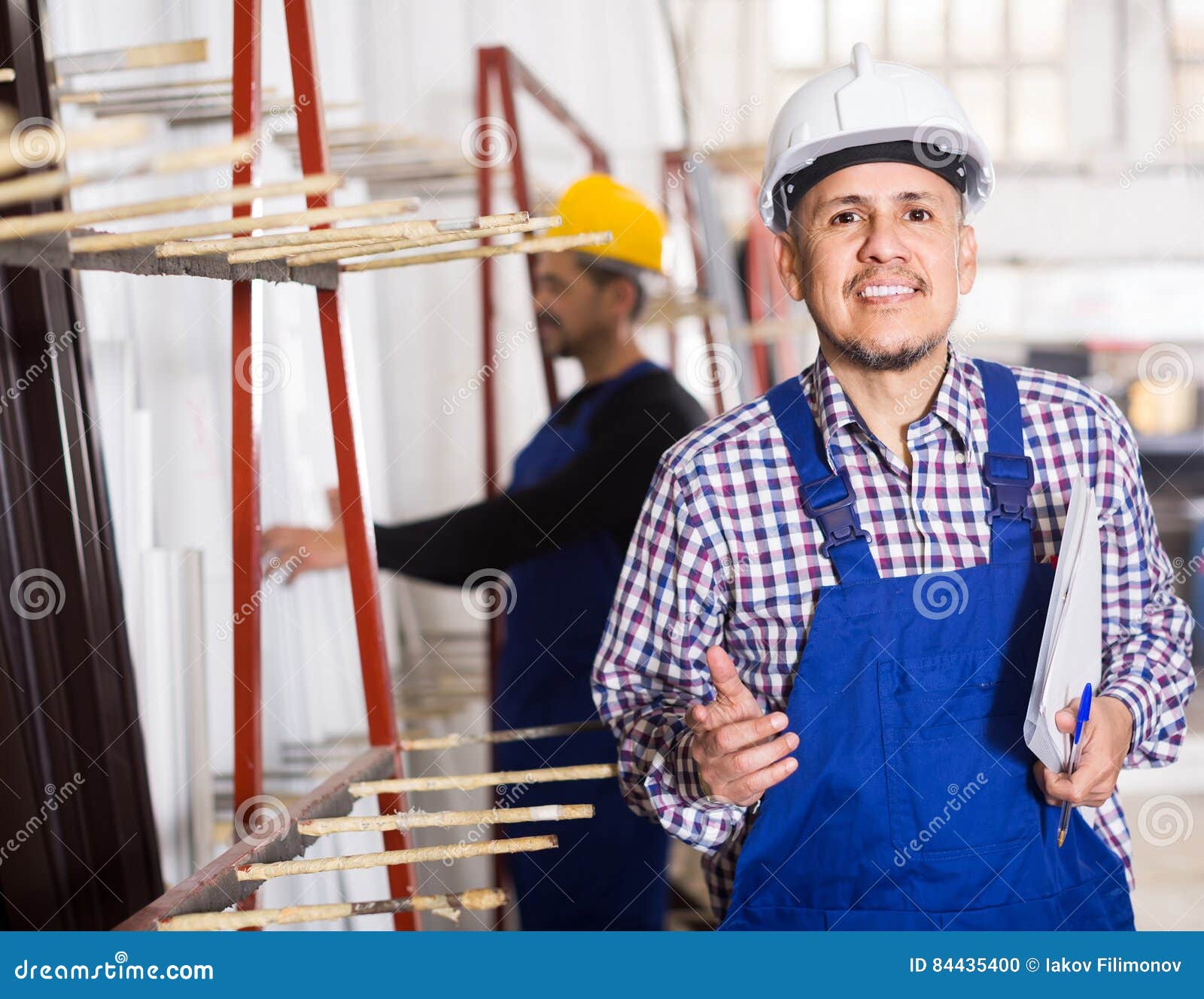 Mechanical Engineer Inspecting the Work of Labour at Factory Stock ...