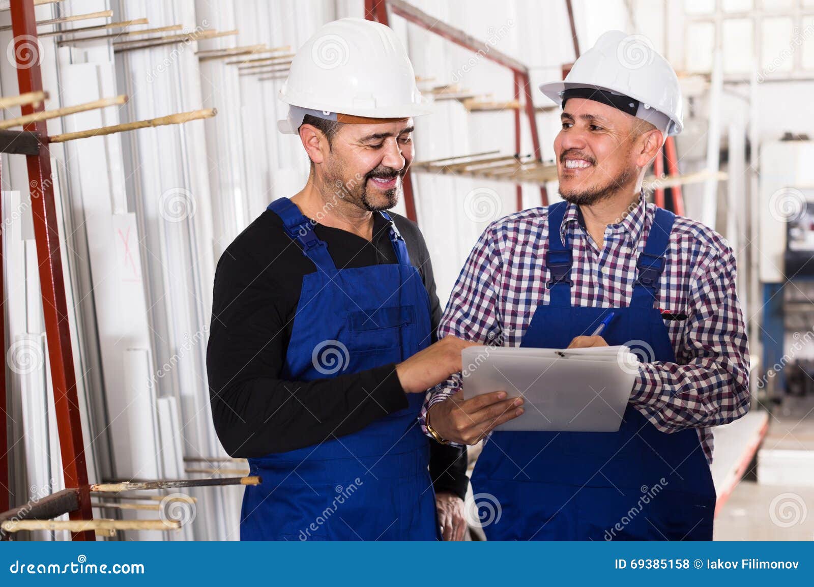 Mechanical Engineer Inspecting the Work of Labour at Factory Stock ...