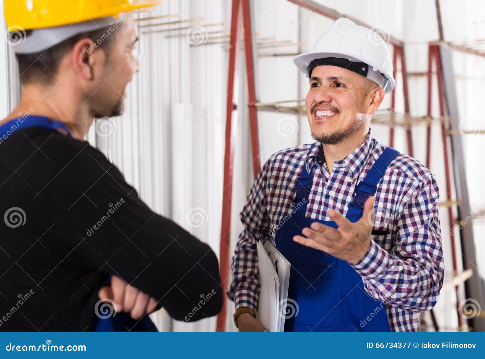 Mechanical Engineer Inspecting the Work of Labour at Factory Stock ...