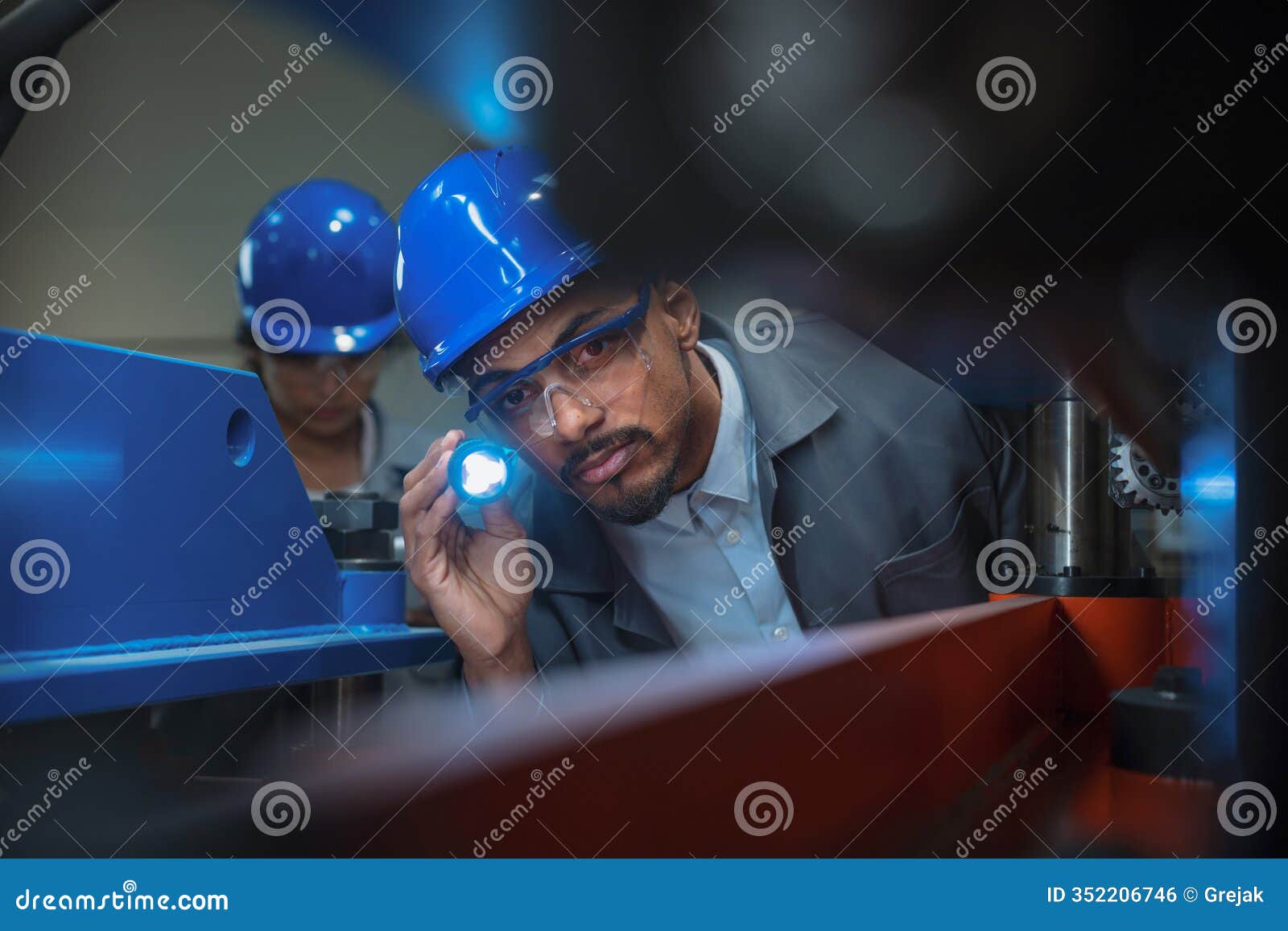 Mechanical Engineers Work in a Team, Using a Flashlight for Inside ...
