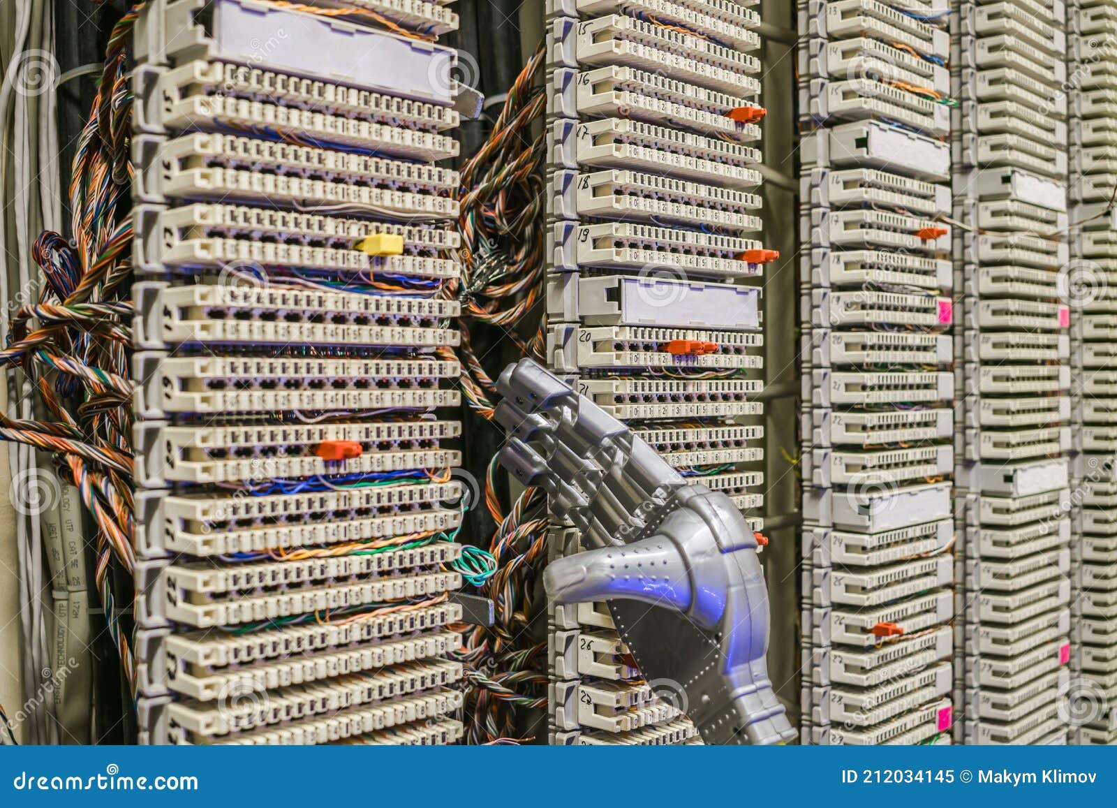 A Mechanical Hand is Next To the Ip Telephony Patch Panel. the Robot ...